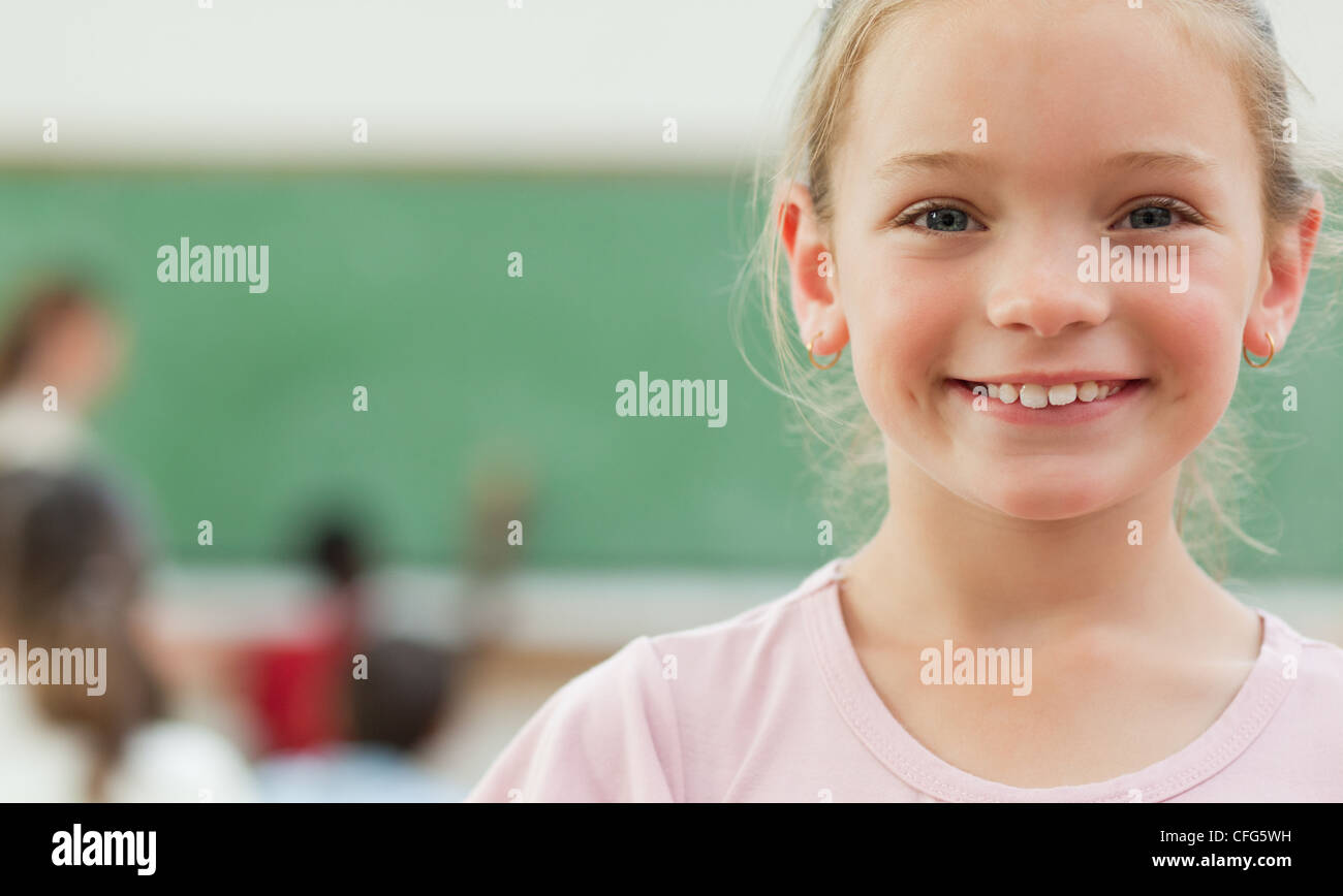 Happy smiling student standing in classroom Stock Photo - Alamy