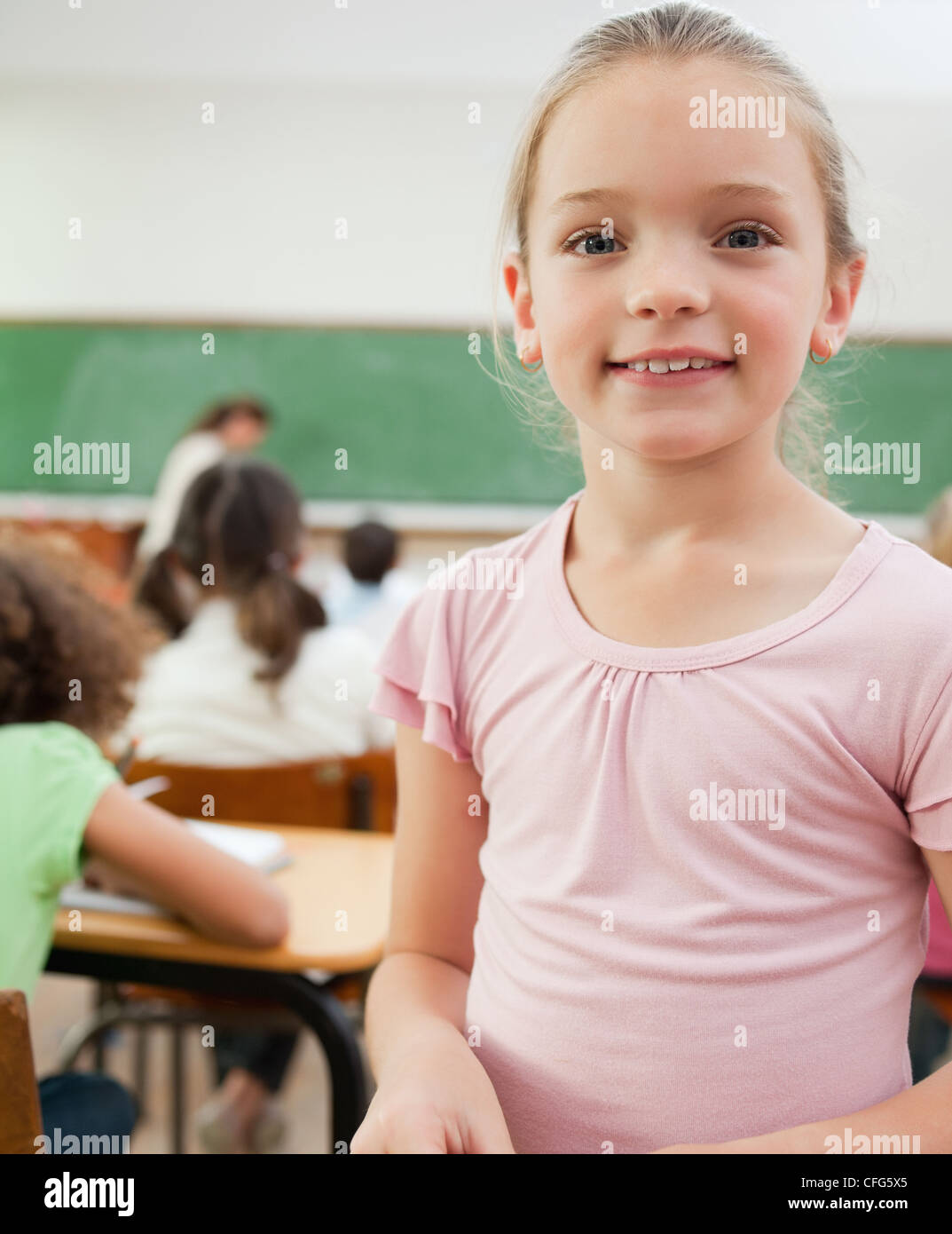 Girl smiling in classroom Stock Photo - Alamy