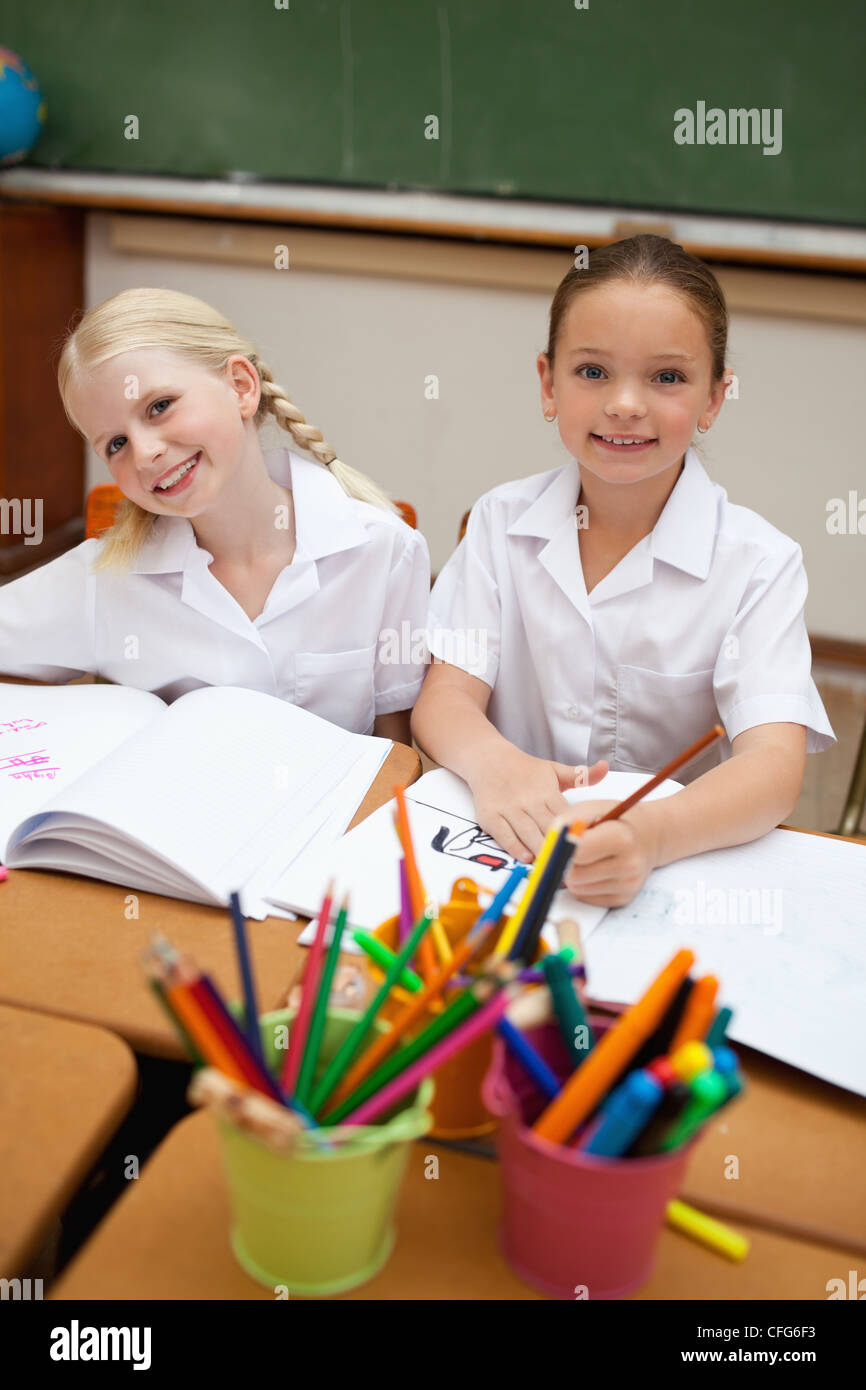 Smiling girls painting during class Stock Photo - Alamy