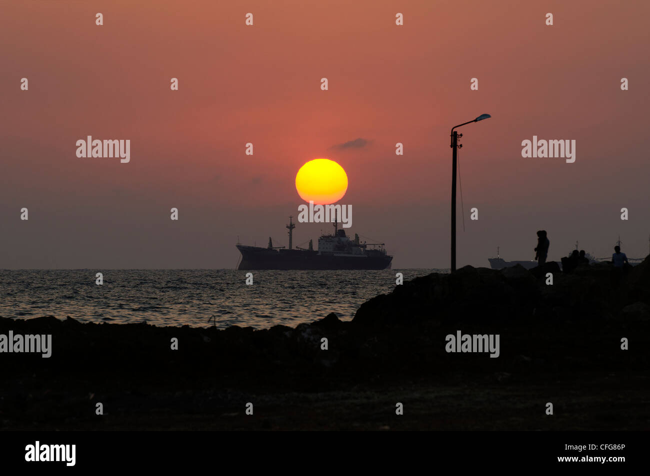 Tartus. Syria. View of the Mediterranean sun setting over large ship ...