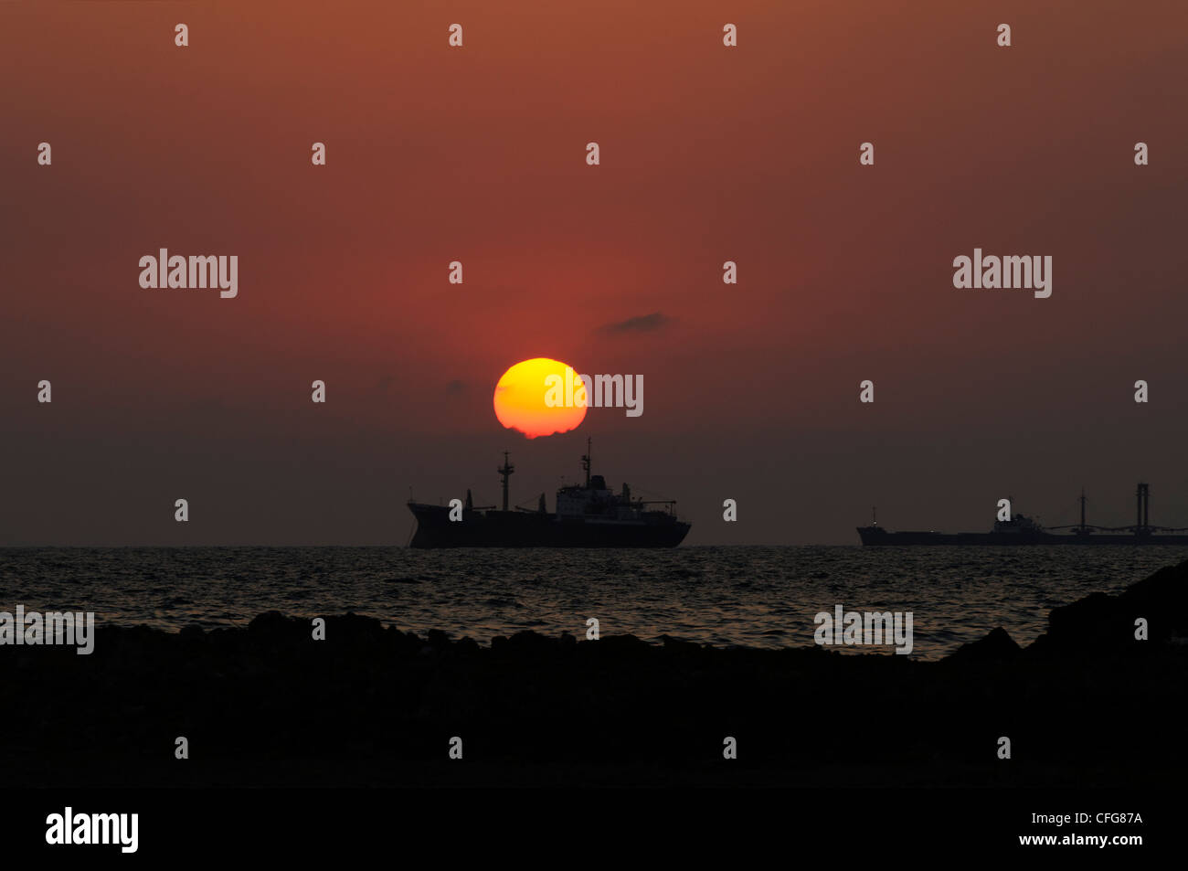 Tartus. Syria. View of the Mediterranean sun setting over large ship ...