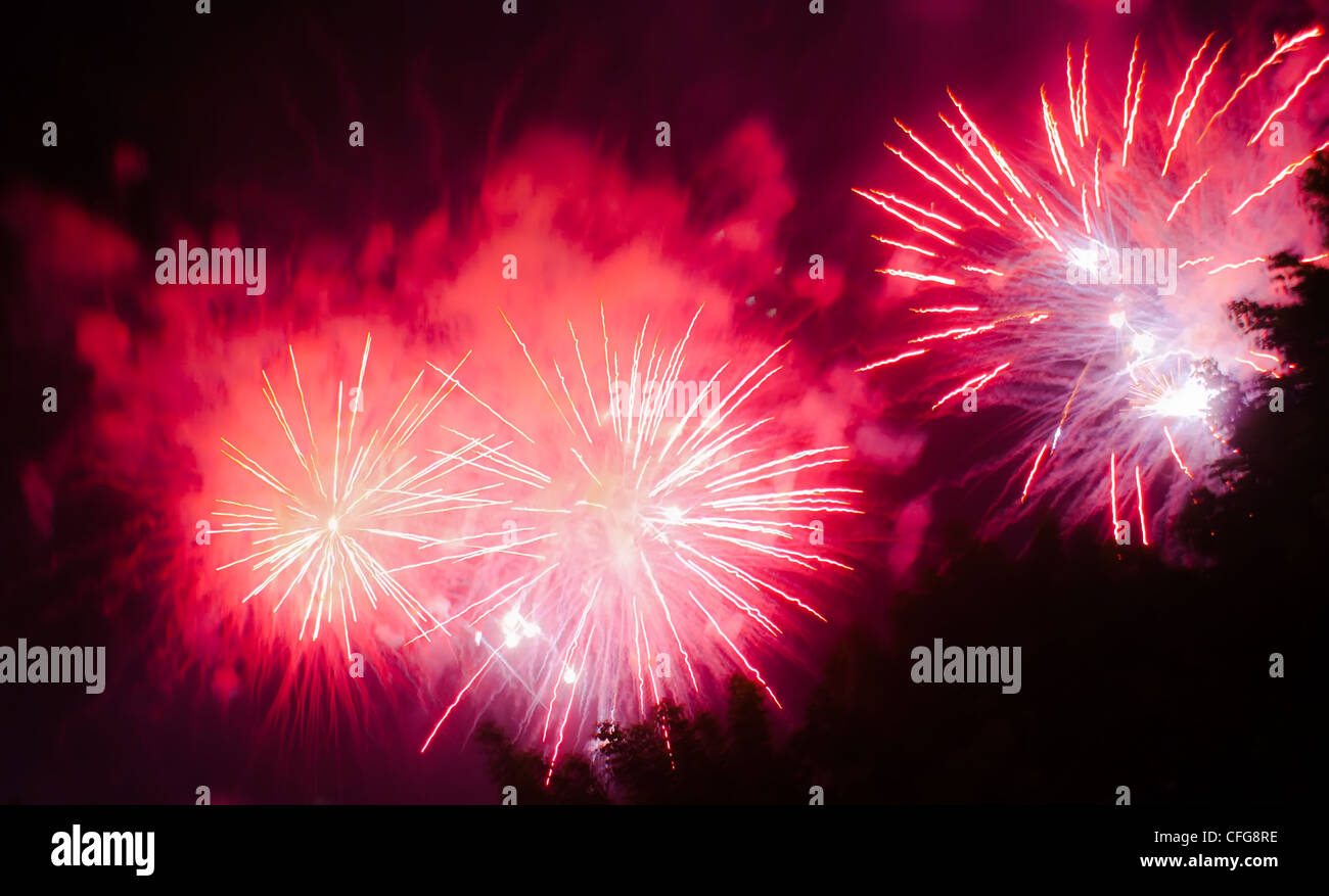 Colorful fireworks over dark sky, displayed during a celebration of ...