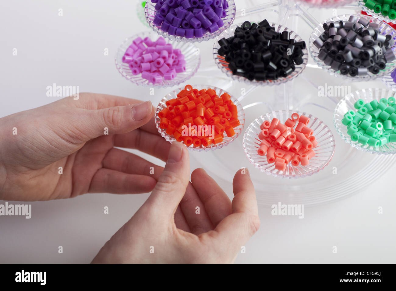 Little blond girl playing with Hama beads Stock Photo - Alamy