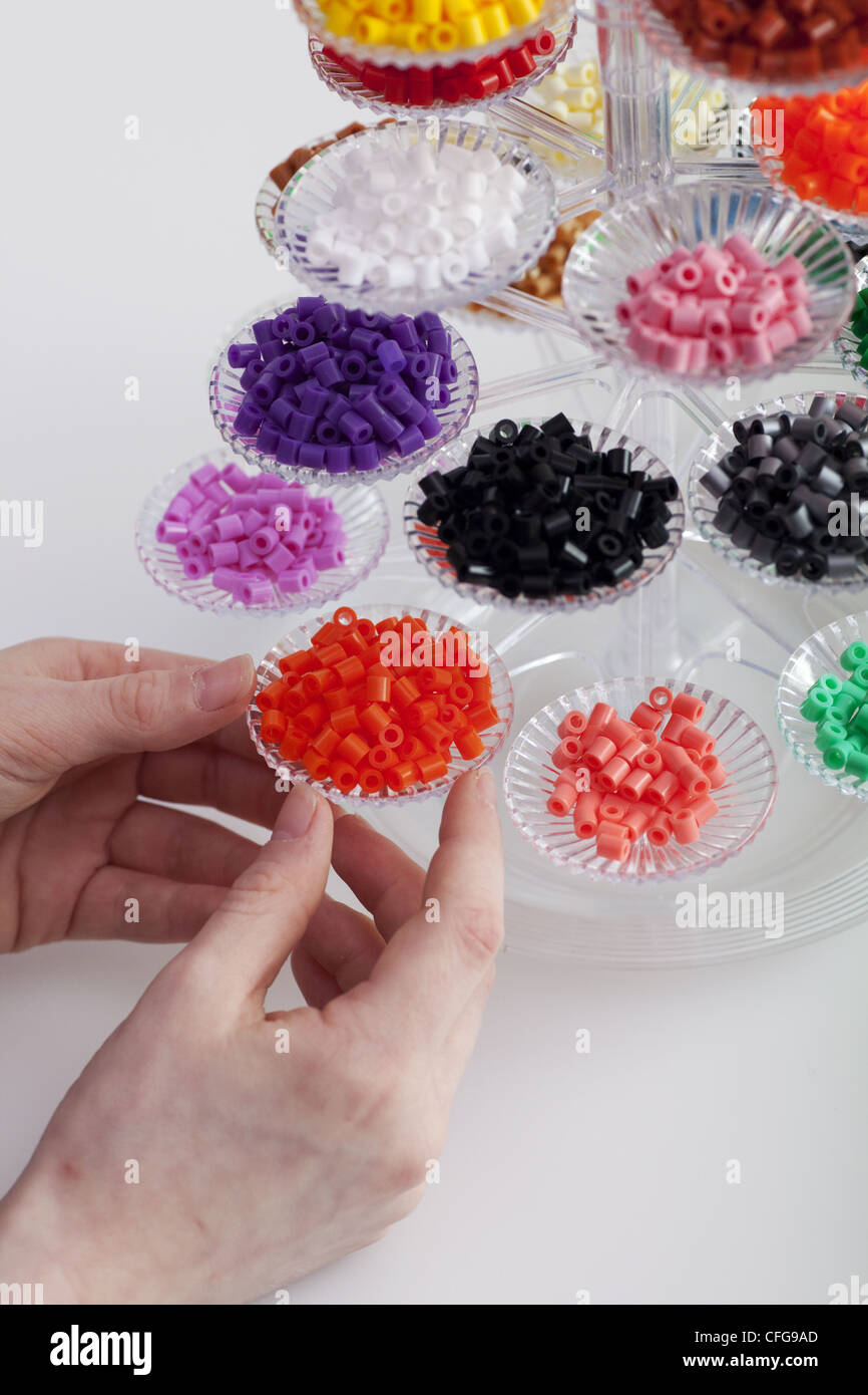 Little blond girl playing with Hama beads Stock Photo - Alamy