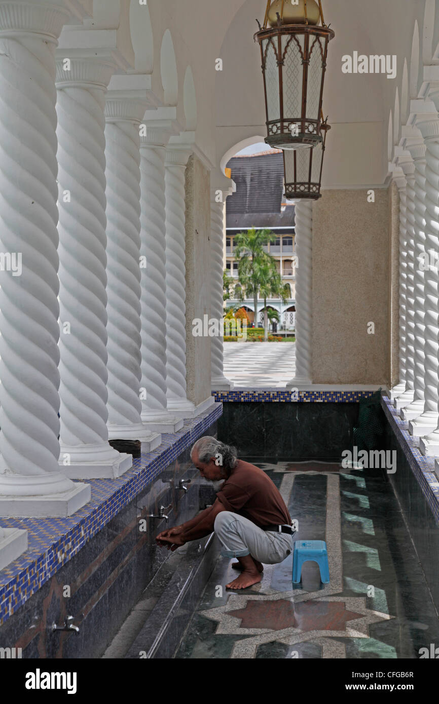 Man washing before prayers at Omar Ali Saifuddien mosque in Bandar Seri ...