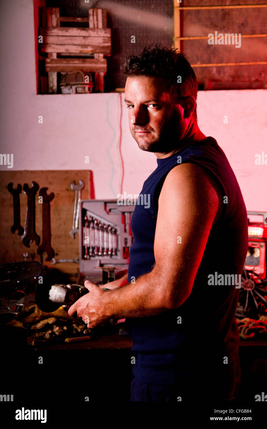 View of a garage mechanic man holding a power tool Stock Photo - Alamy