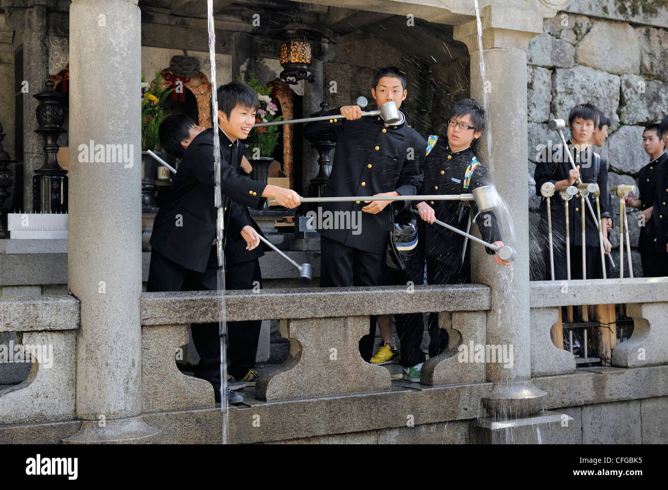 schoolboys scooping holy water at Kiyomizu-dera temple, Kyoto, Japan ...