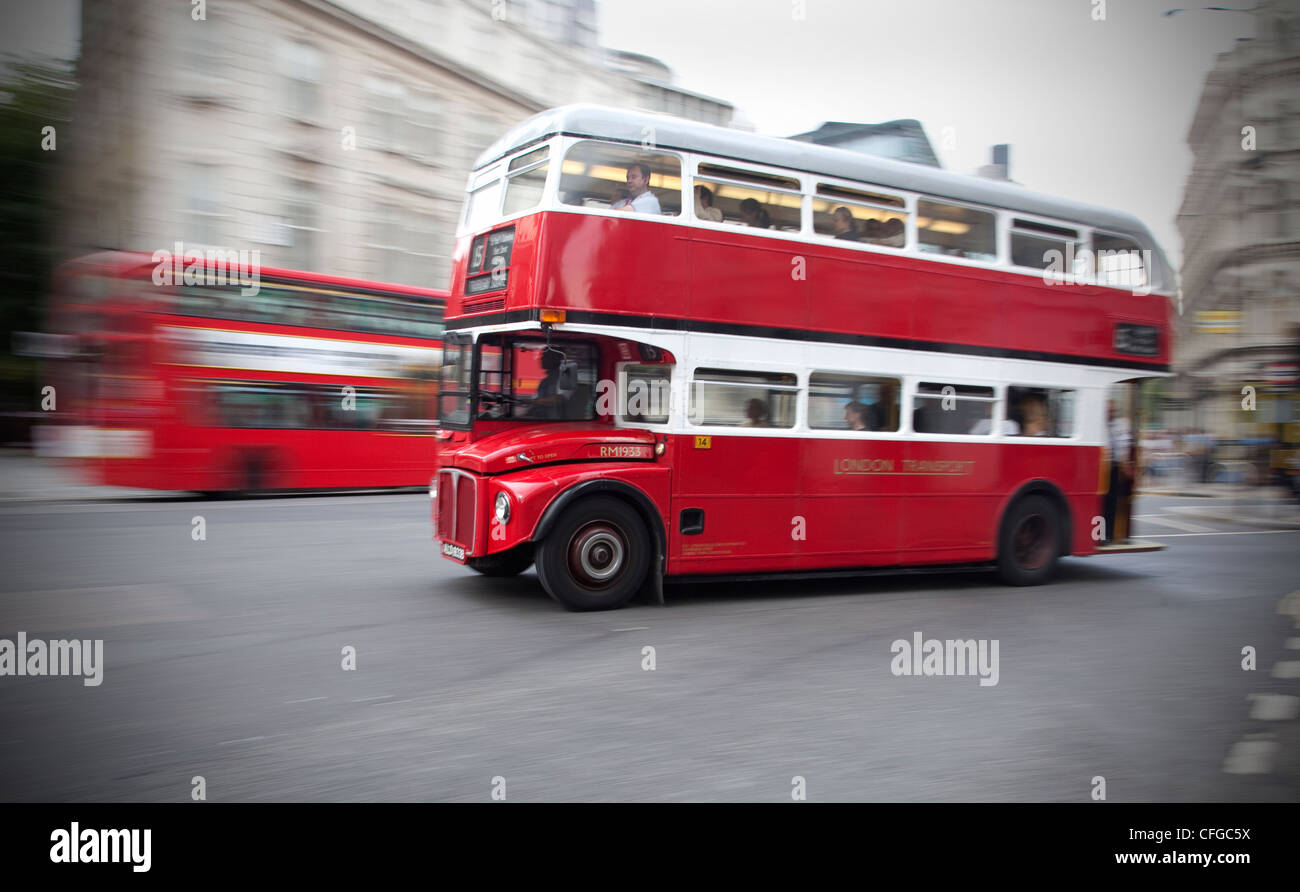 Iconic red London bus speeding through the city Stock Photo - Alamy