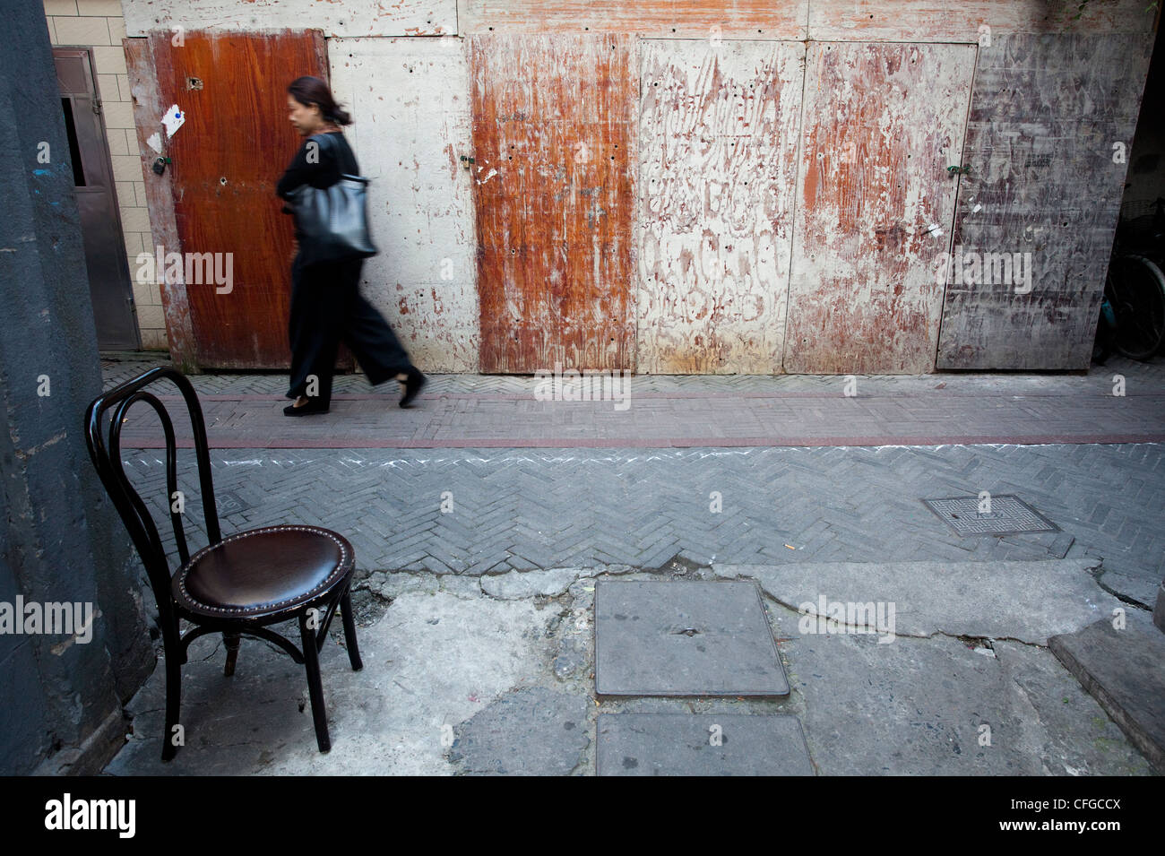 A chinese woman walking through an alleyway in Shanghai, China Stock ...