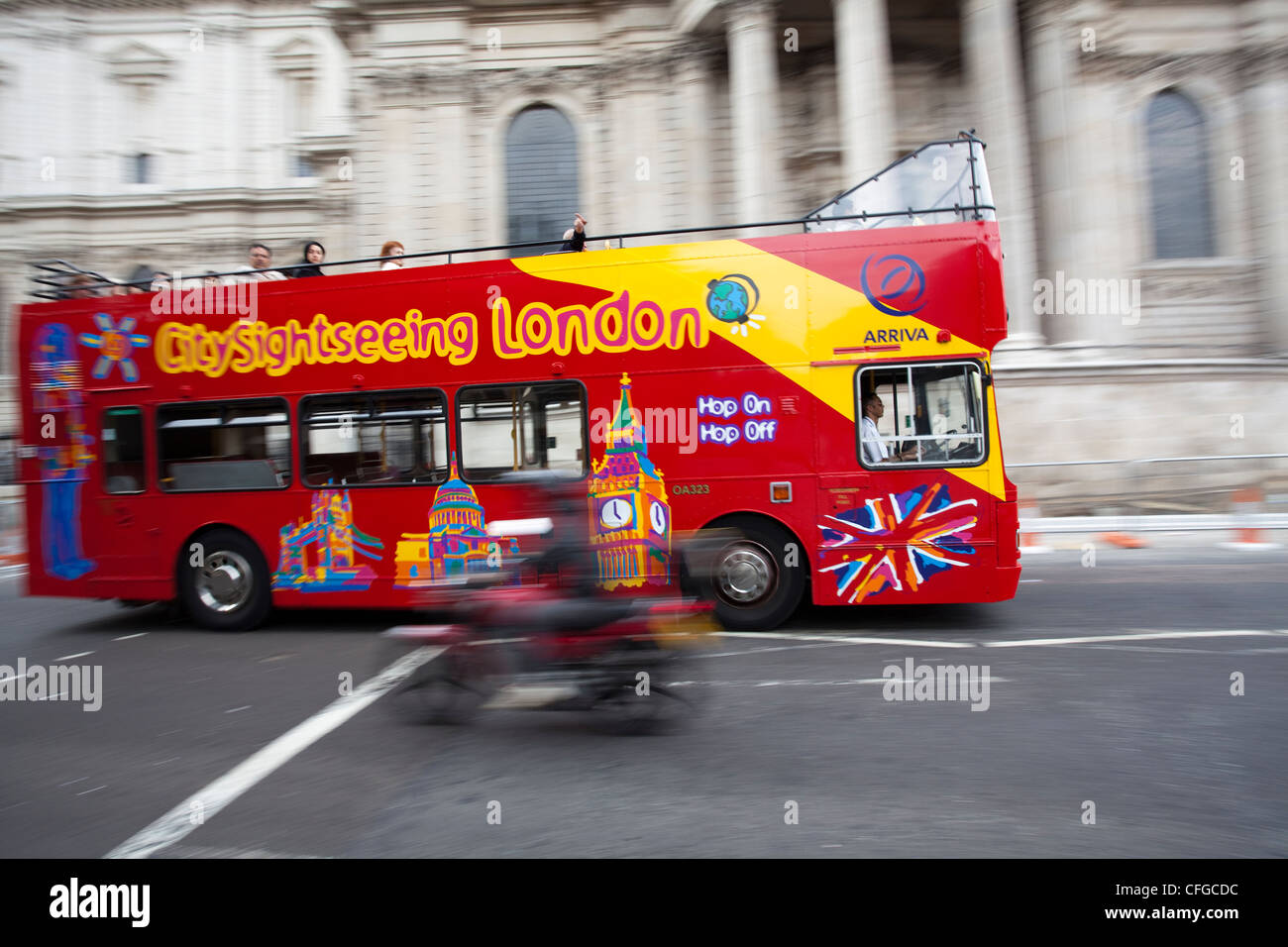 Iconic red London bus speeding through the city Stock Photo - Alamy