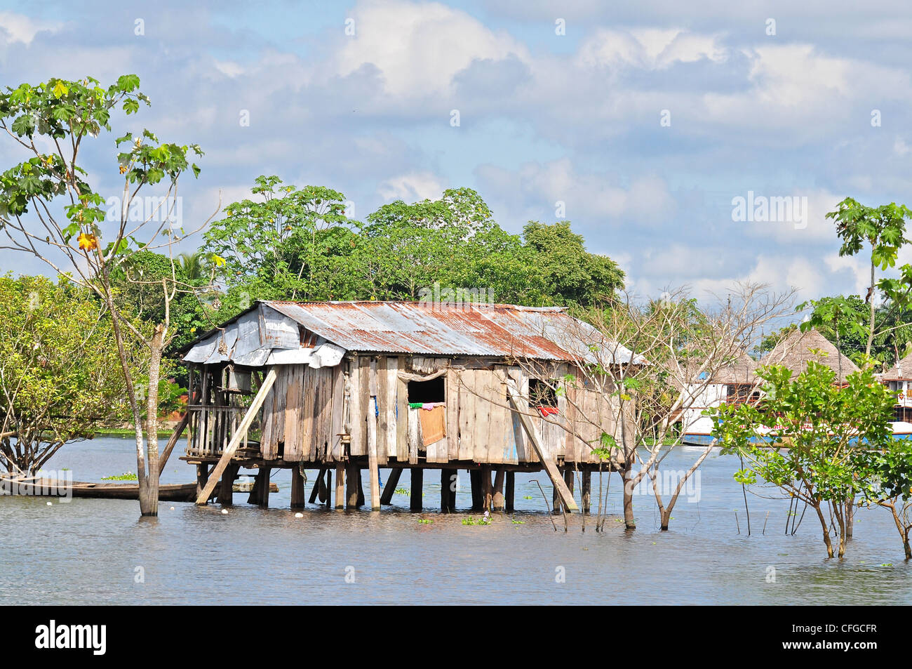 Poor people build huts on stilts in flooded areas of the Amazon River ...