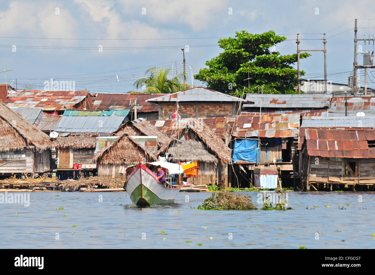 Poor people build huts on stilts in flooded areas of the Amazon River ...