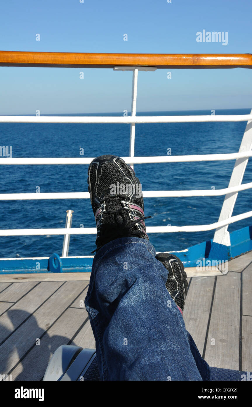 Girl sitting on cruise ship deck Stock Photo - Alamy