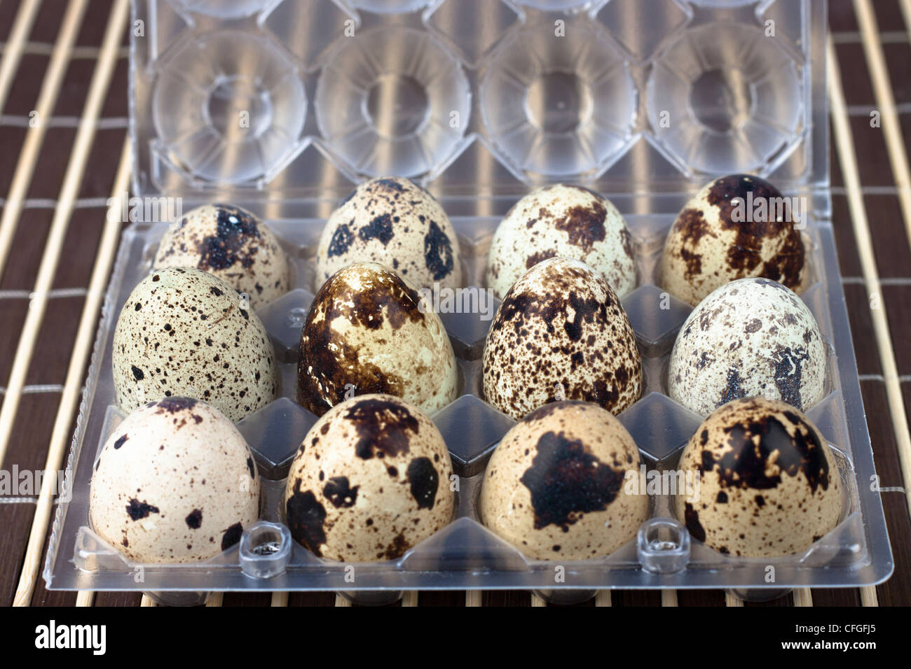 Packaging with a dozen quail eggs Stock Photo - Alamy