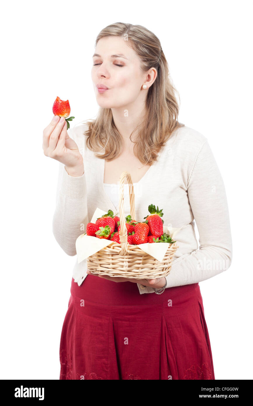 Beautiful young woman enjoying fresh strawberries, isolated on white ...