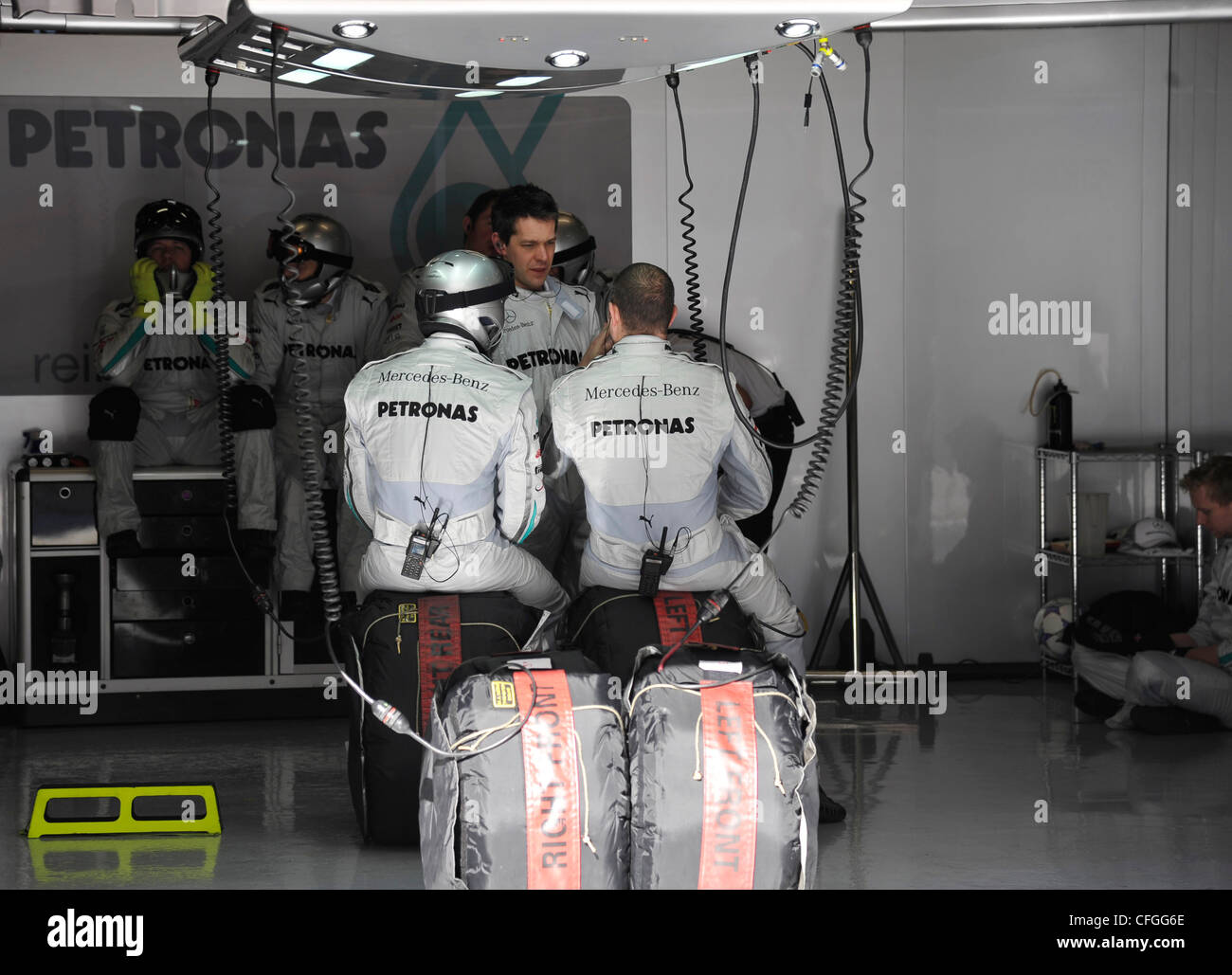 Mercedes Mechanics sit on racing slicks during Formula One testing ...