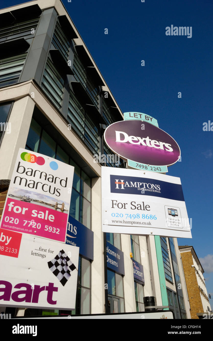 Estate agent boards outside an office block Stock Photo - Alamy