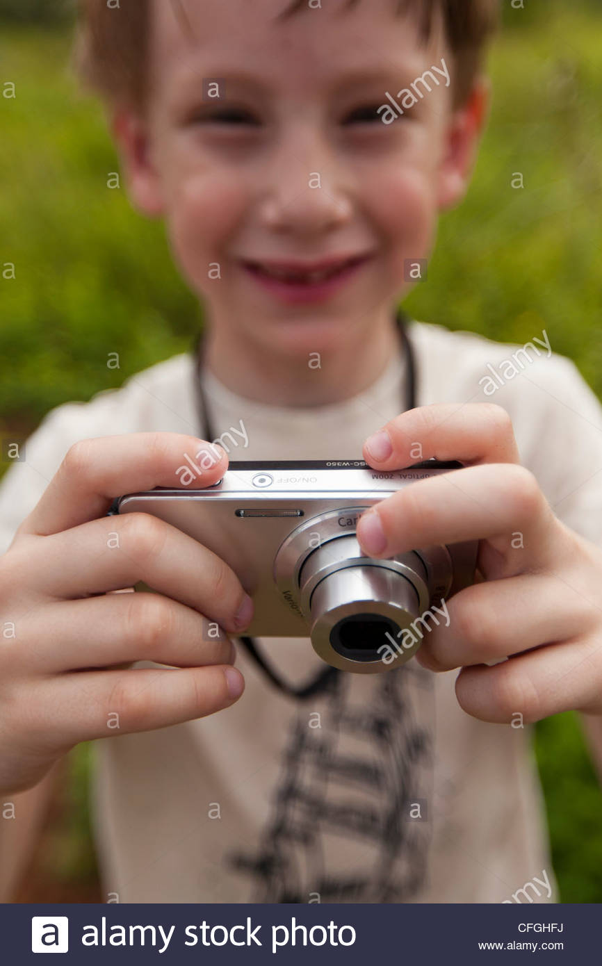A smiling boy with a digital camera Stock Photo - Alamy