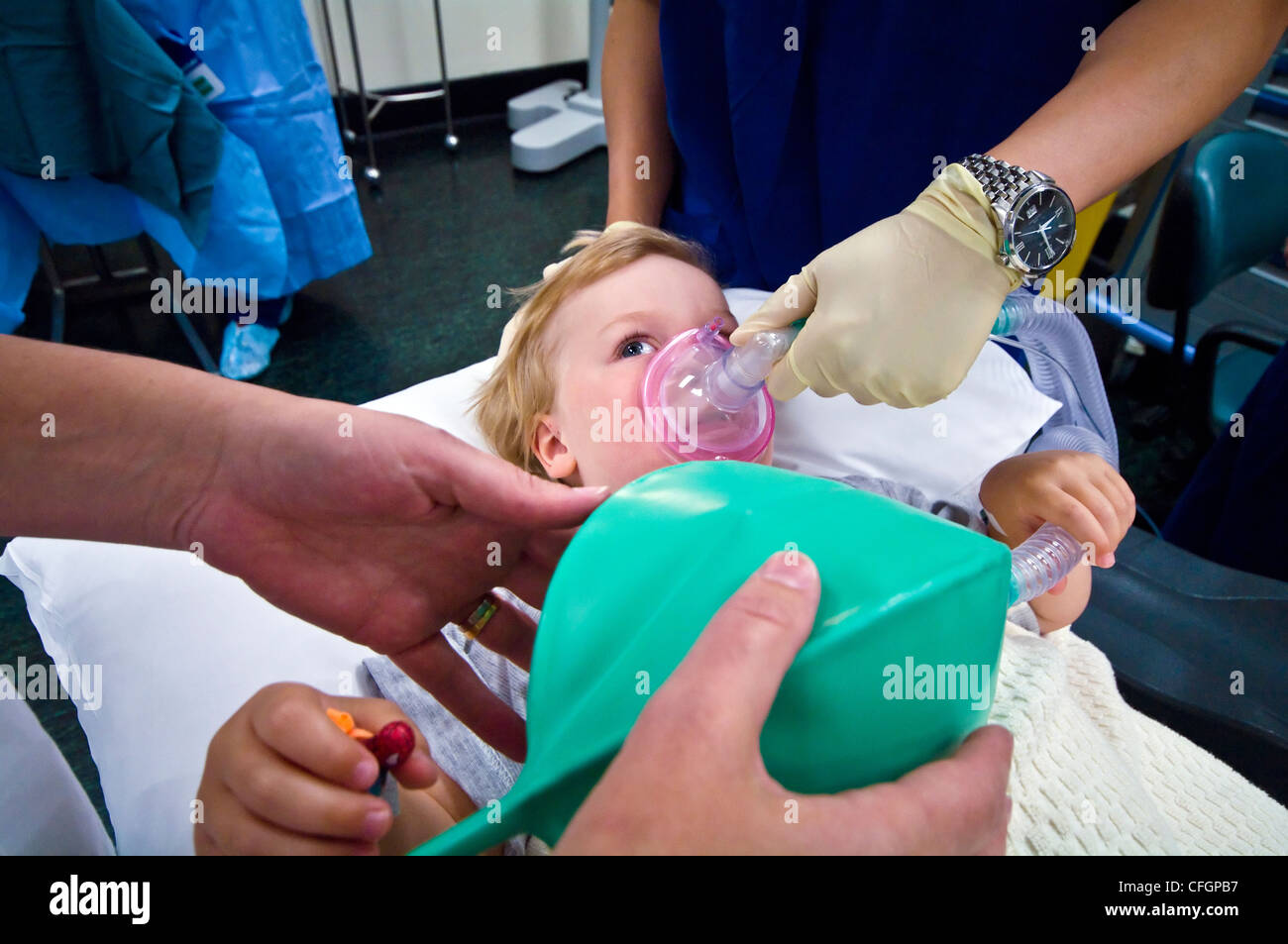 A boy inhales anaesthetic in an operating theatre for ear surgery Stock ...