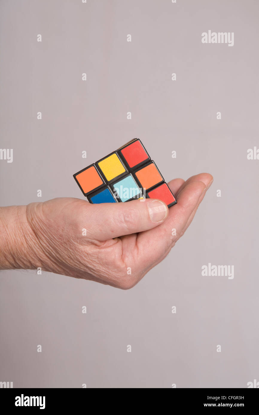 Hand holding a Rubic cube Stock Photo - Alamy