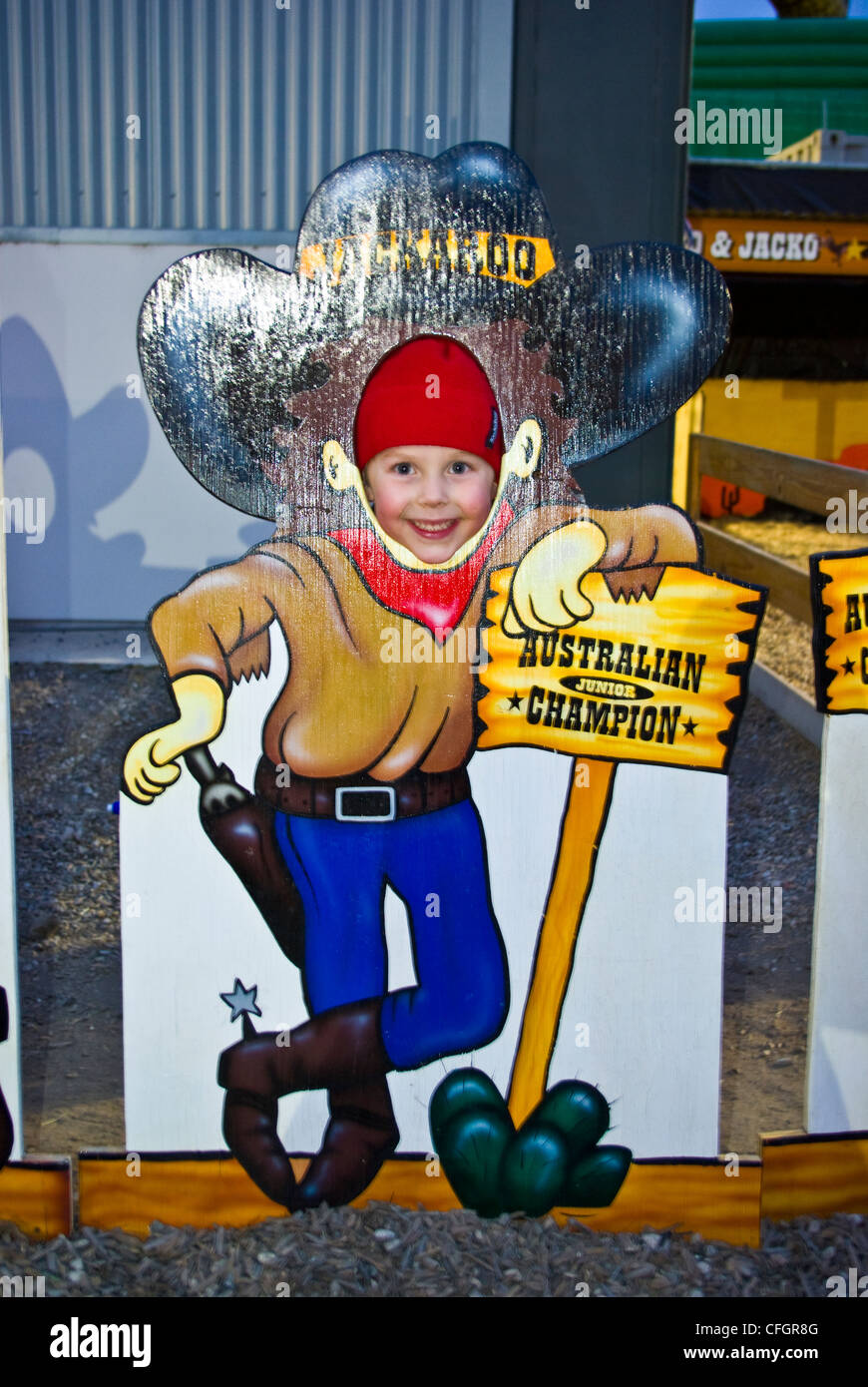 A small boy poses for a photo as a jackaroo in a fair side show Stock ...
