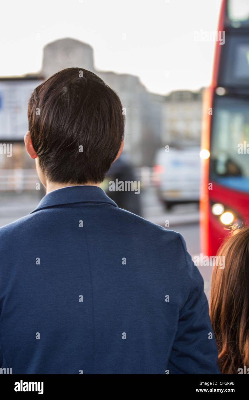 People wait for a bus in London Stock Photo - Alamy