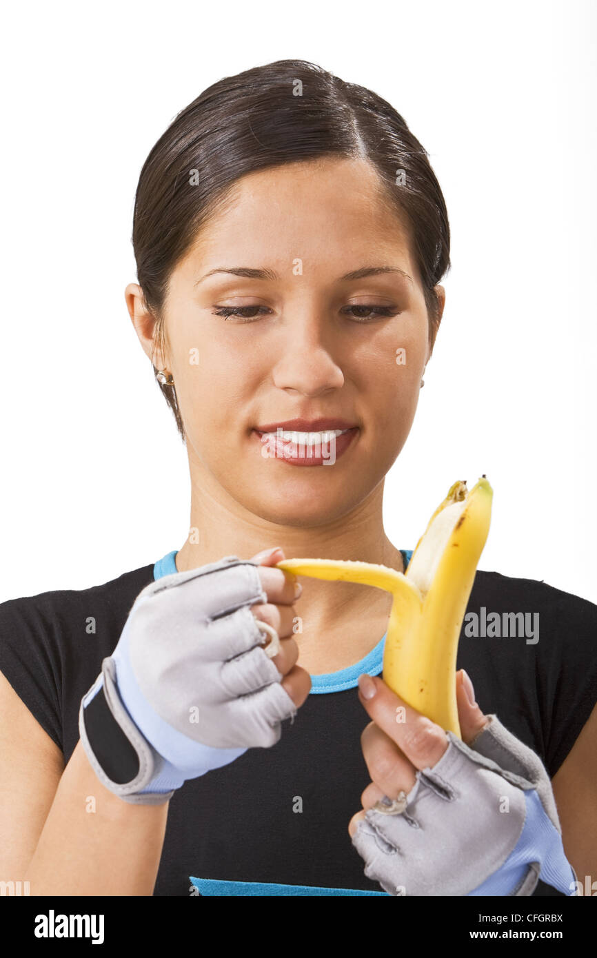 Sports girl eating a banana during a training break Stock Photo - Alamy
