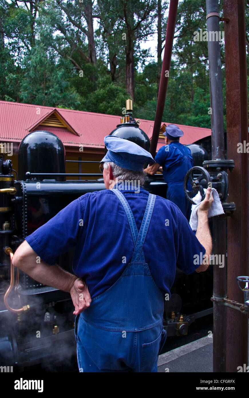 An antique steam train crew fills an engine boiler with water Stock ...