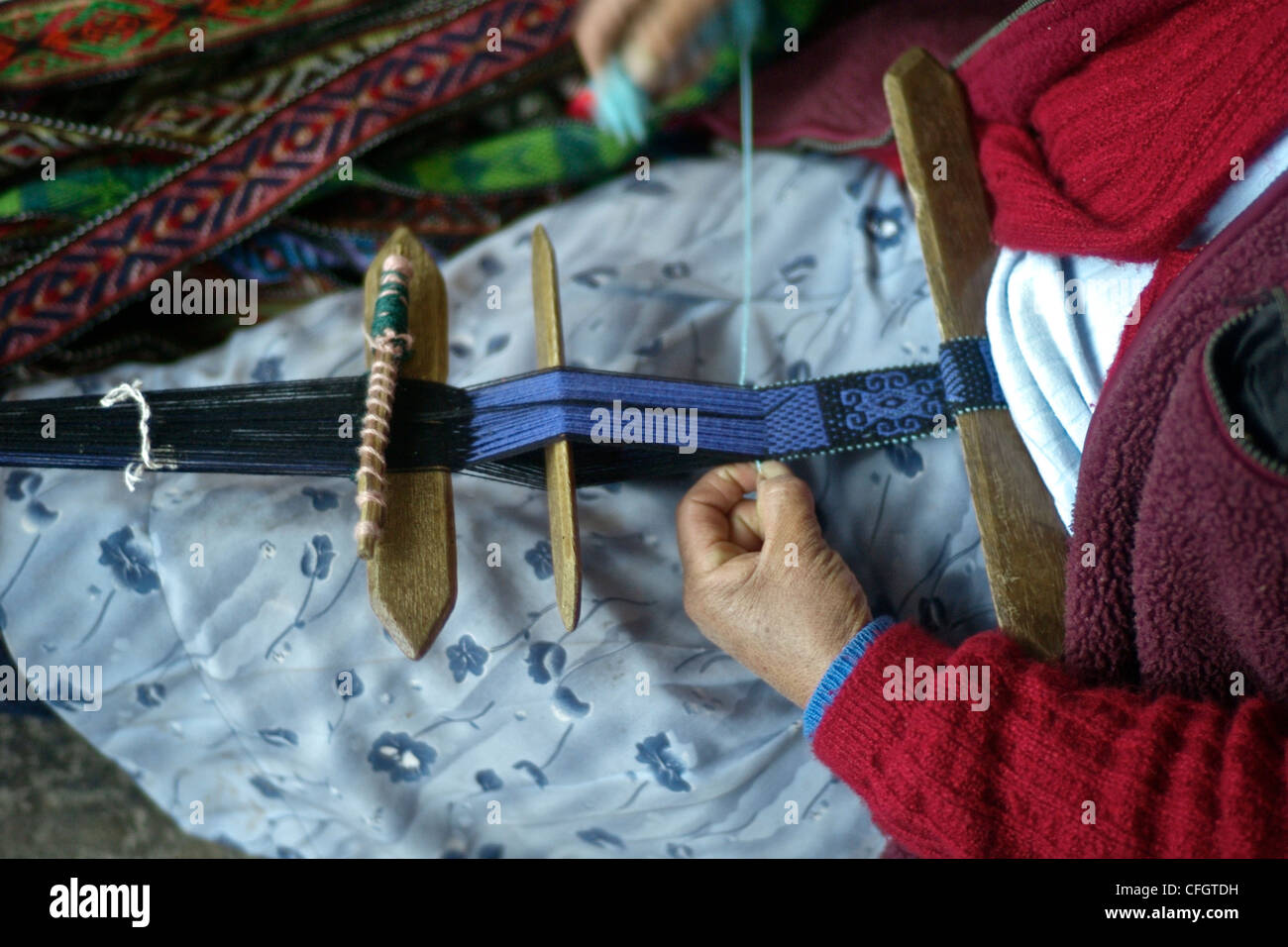 A Quechua woman weaving symbols into textiles Stock Photo - Alamy