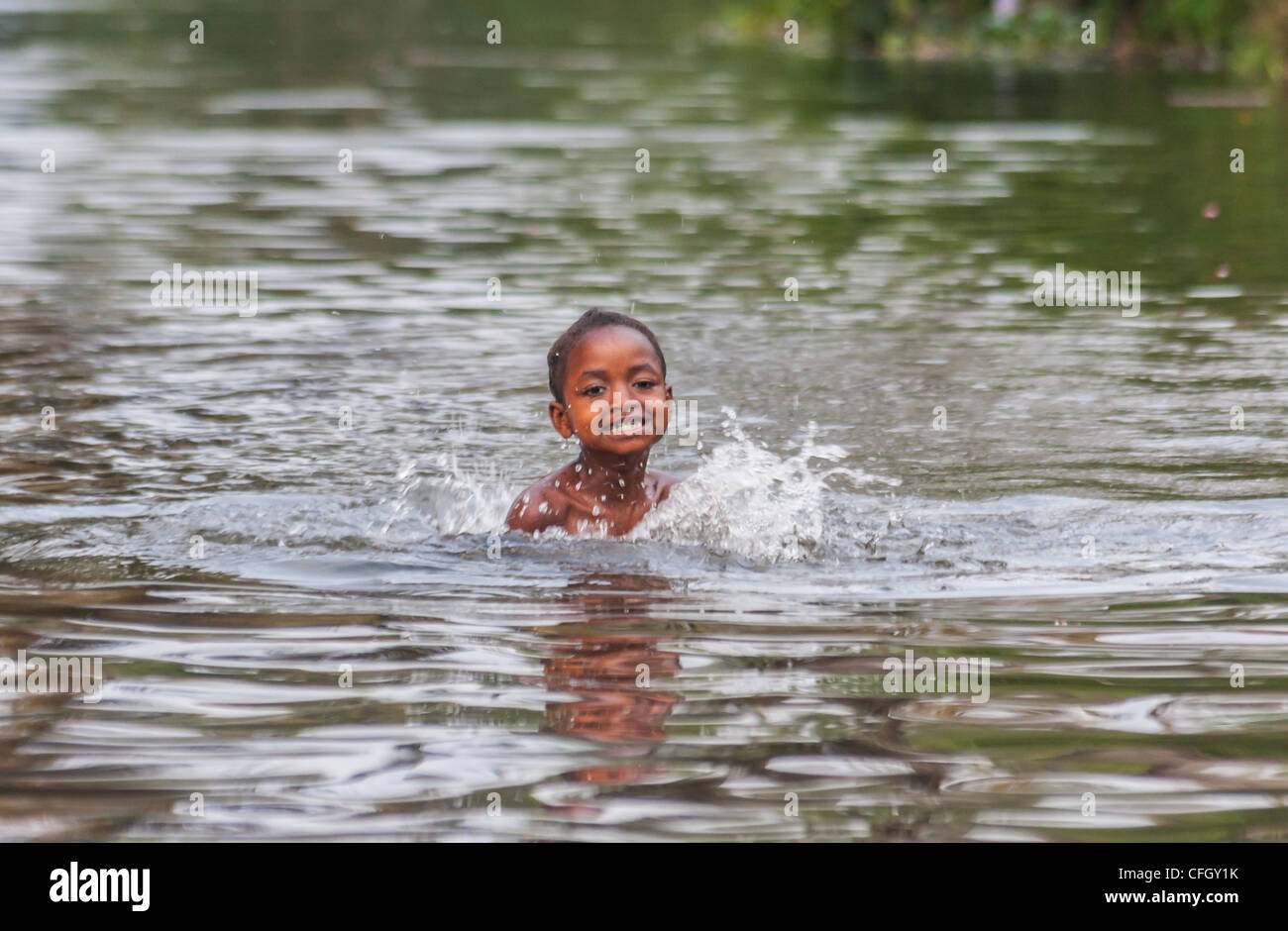 Child swimming in the Pangalanes channel, eastern Madagascar Stock ...