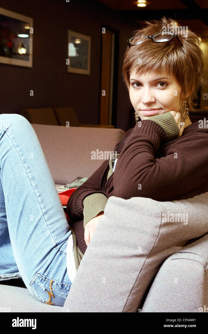 Portrait of a Young Woman on a Couch Stock Photo - Alamy