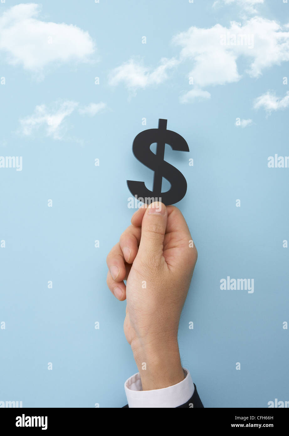 Businessman's hand holding dollar sign Stock Photo - Alamy