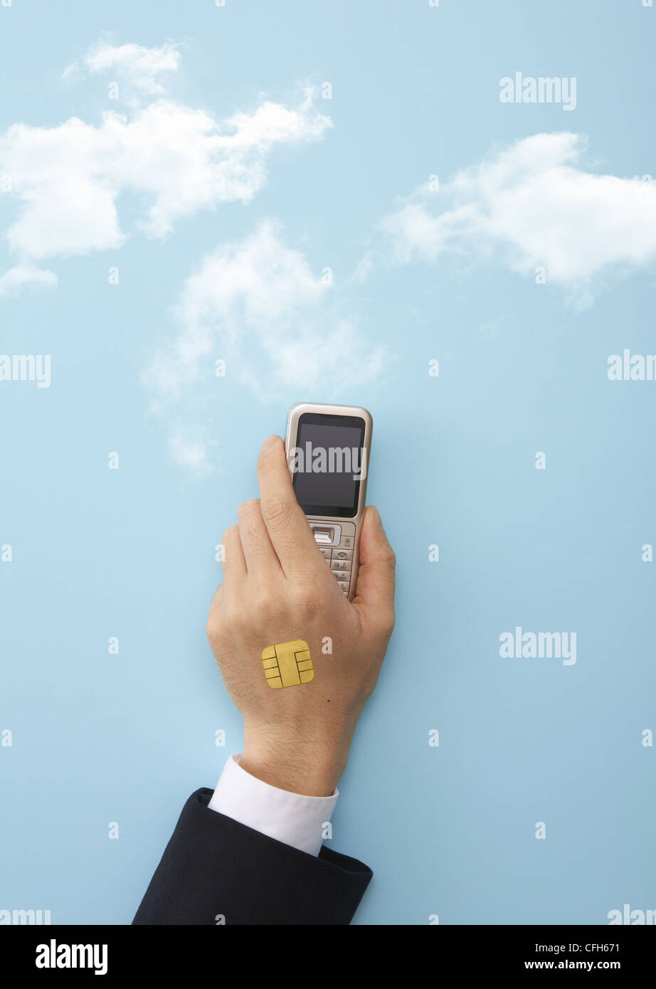 Businessman's hand with IC chip holding mobile phone Stock Photo - Alamy