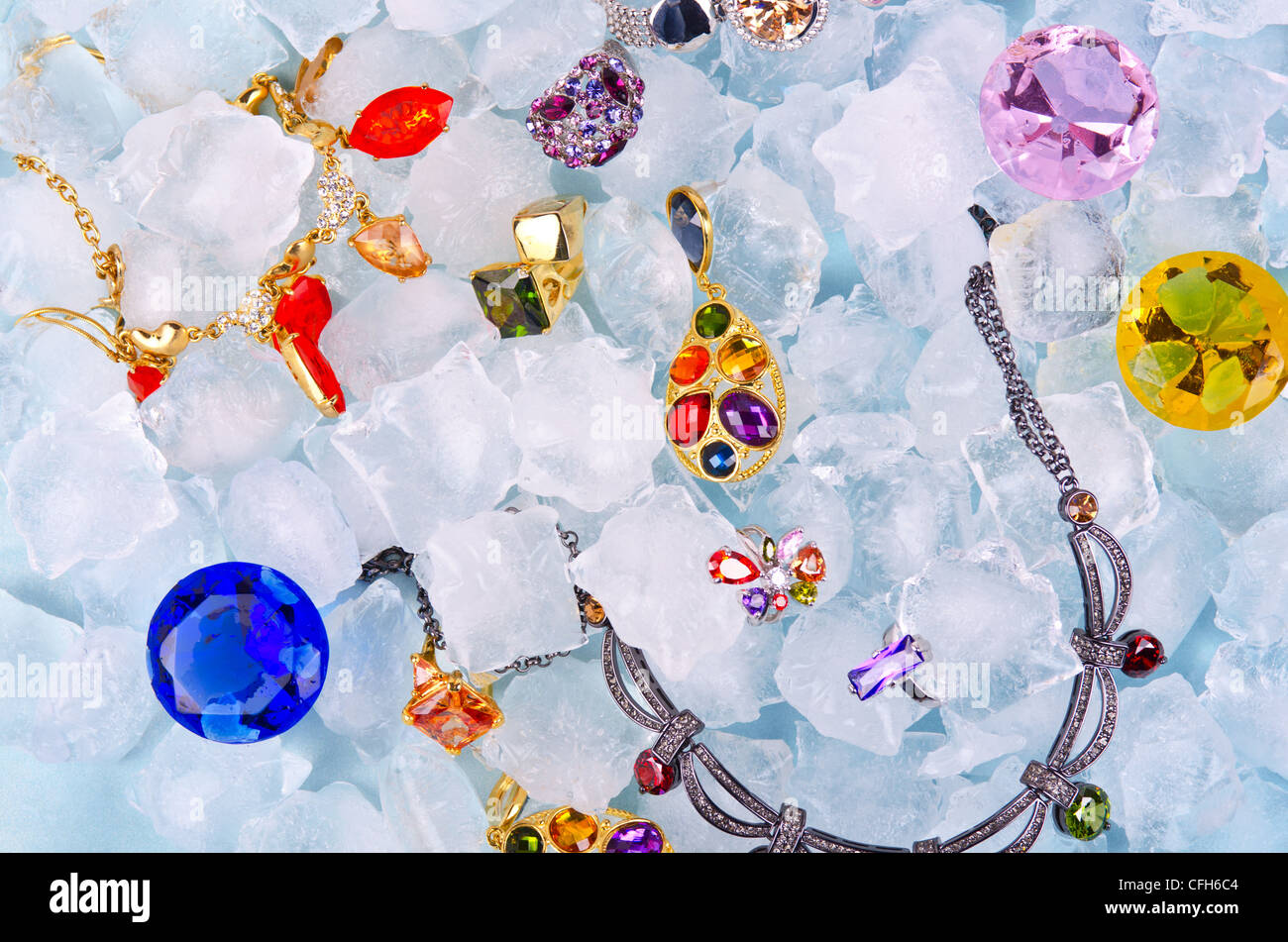 Jewels at blue cube of ice background Stock Photo - Alamy