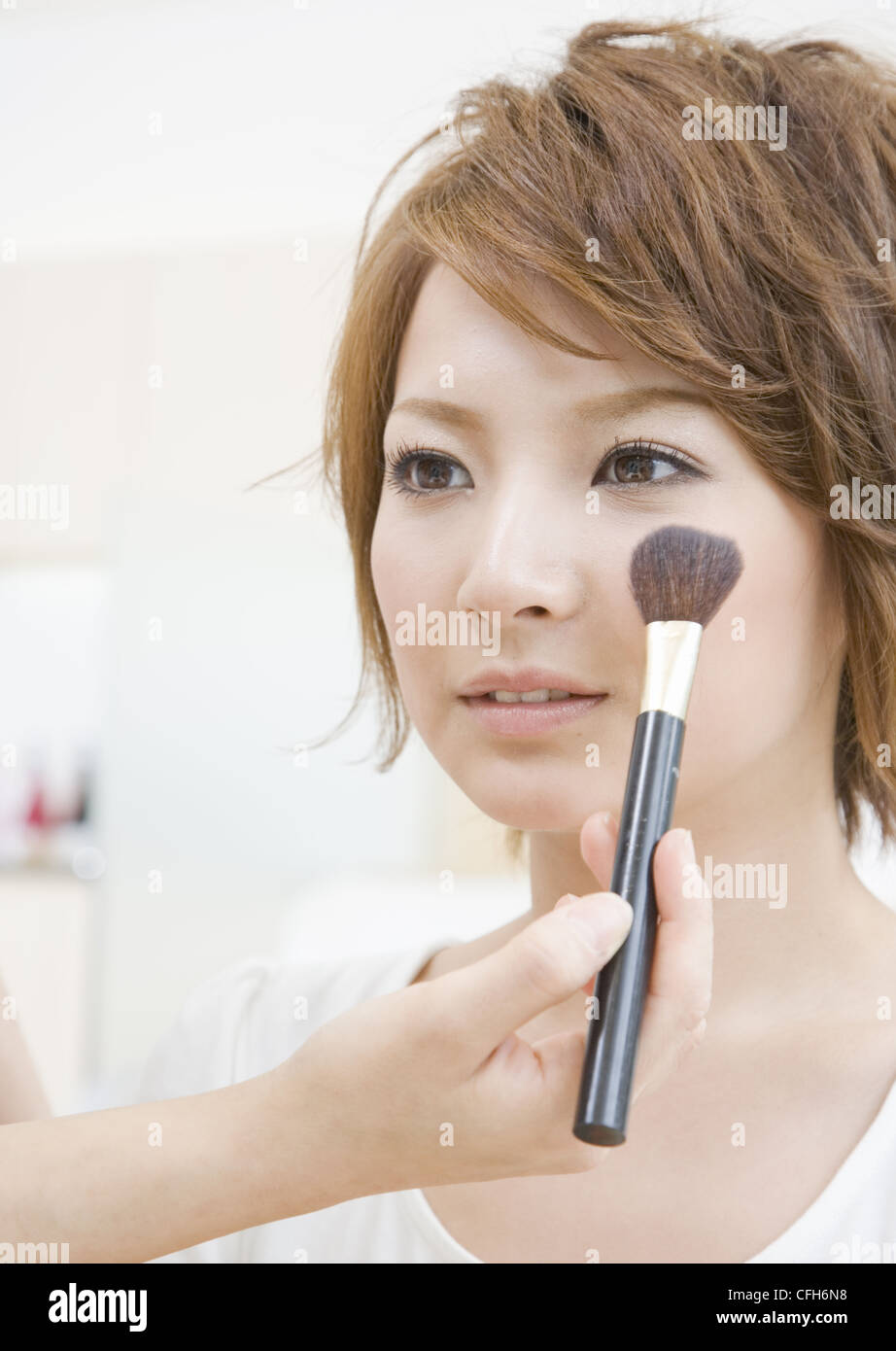 Young woman getting make-up done Stock Photo - Alamy