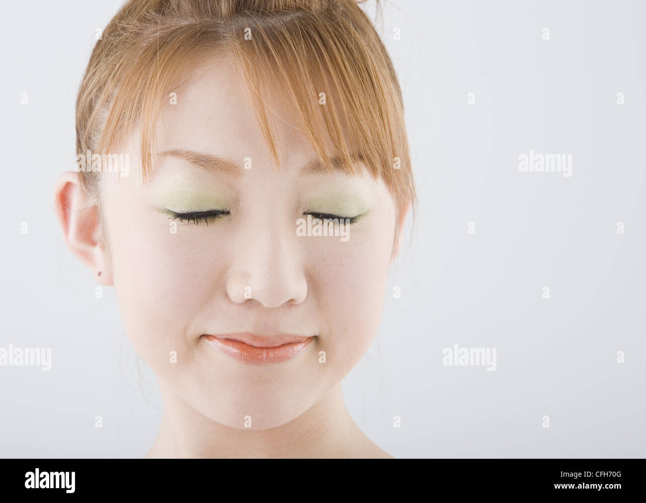 Young woman closing eyes Stock Photo - Alamy