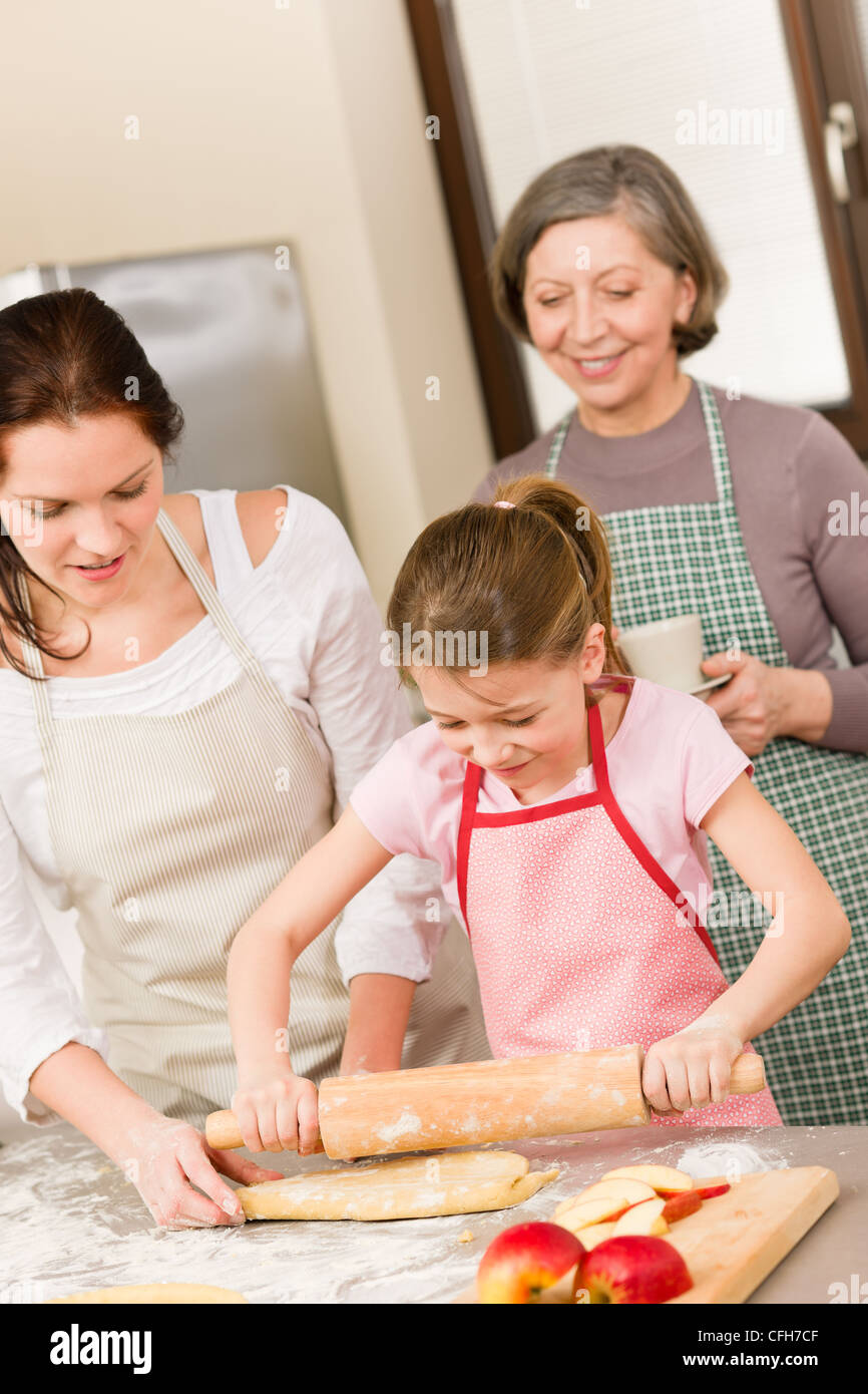 Mother and daughter making apple pie together grandmother check recipe ...