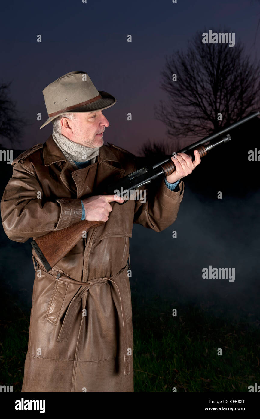 man with cowboy hat, long leather coat and riot gun Stock Photo - Alamy