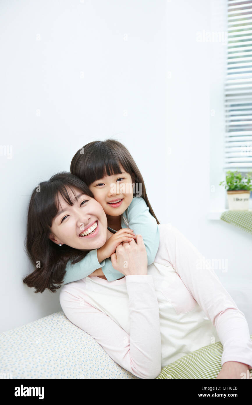 The girl hugging the woman from back Stock Photo - Alamy