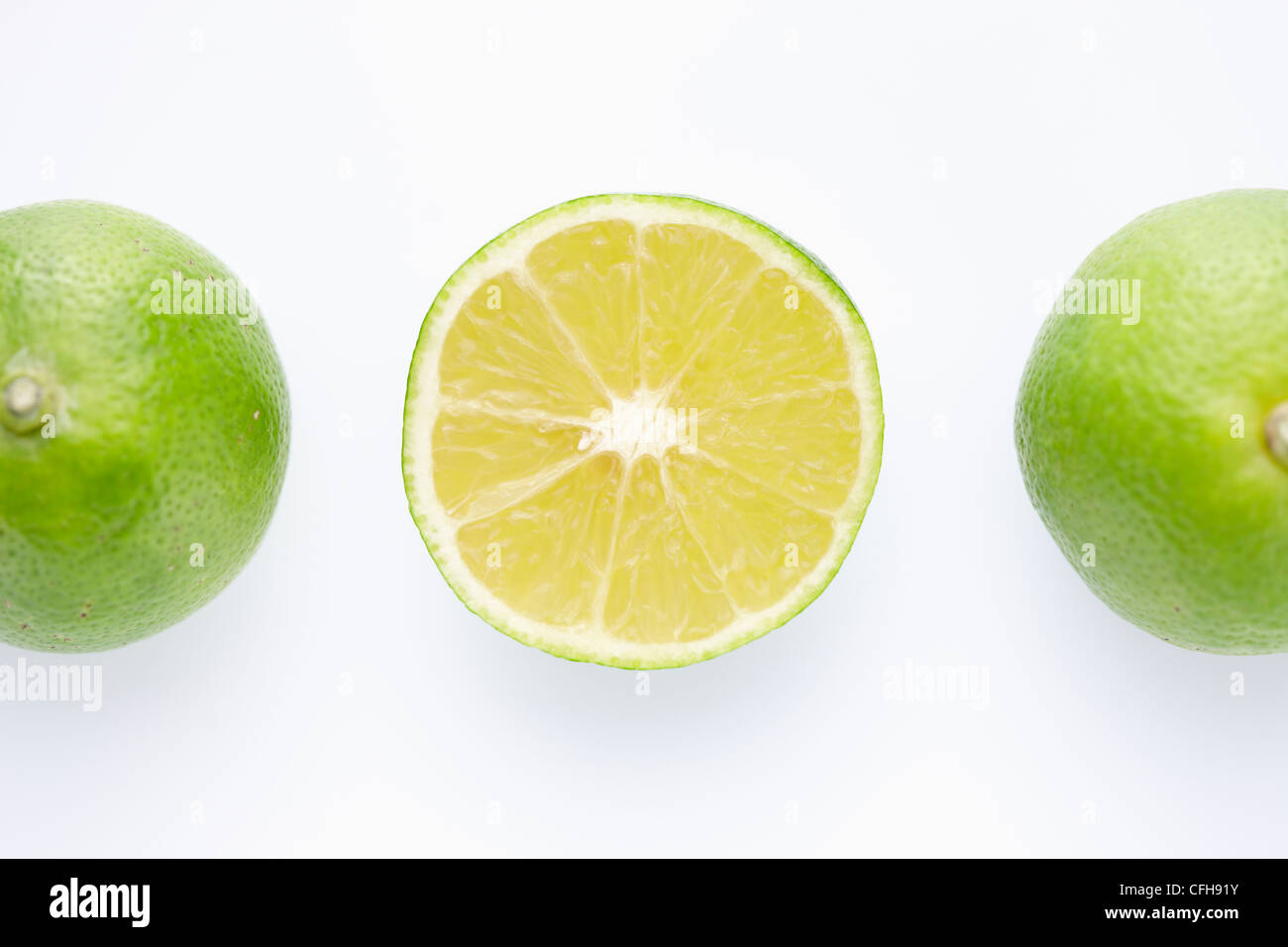 The whole limes and a lime in half Stock Photo - Alamy
