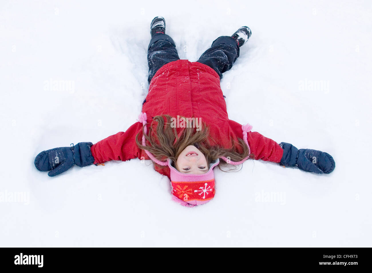 Girl Lying Down in Snow Stock Photo - Alamy