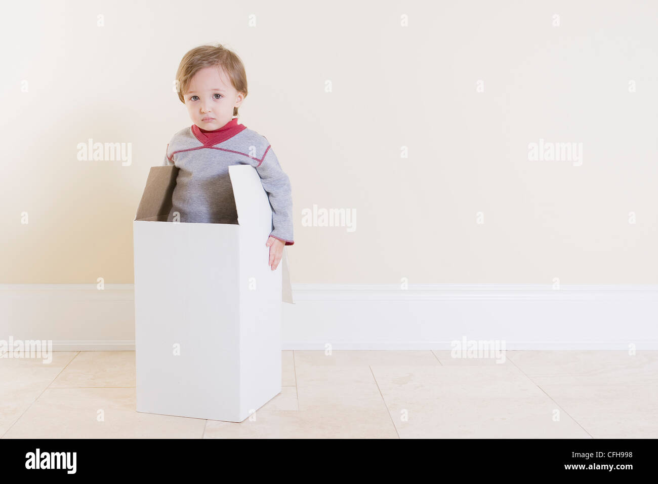 Little Boy Playing with Box Stock Photo - Alamy