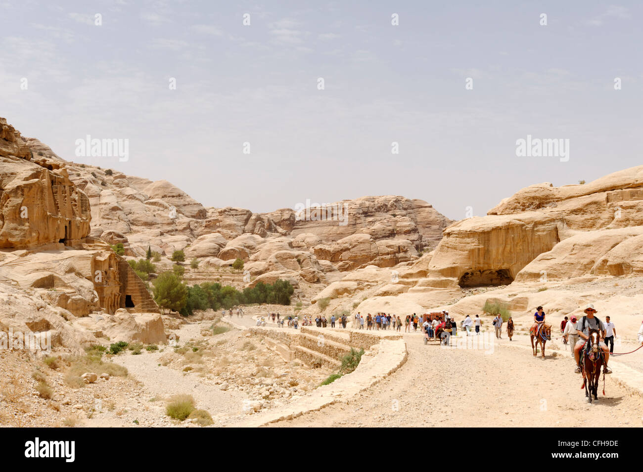Petra. Jordan. View of tourists on the modern gravel path that winds ...