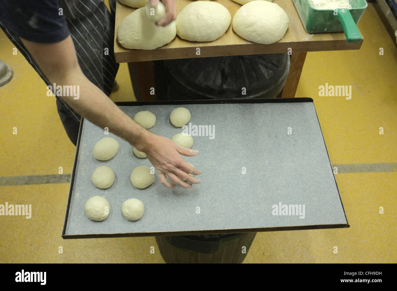 An artisan baker producing bread and buns Stock Photo - Alamy
