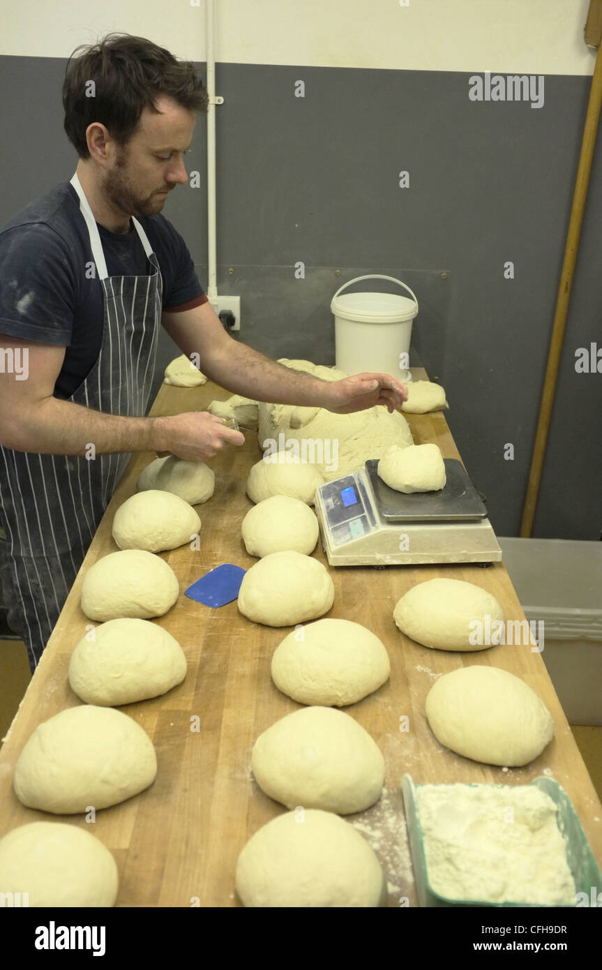 An artisan baker producing bread and buns Stock Photo - Alamy
