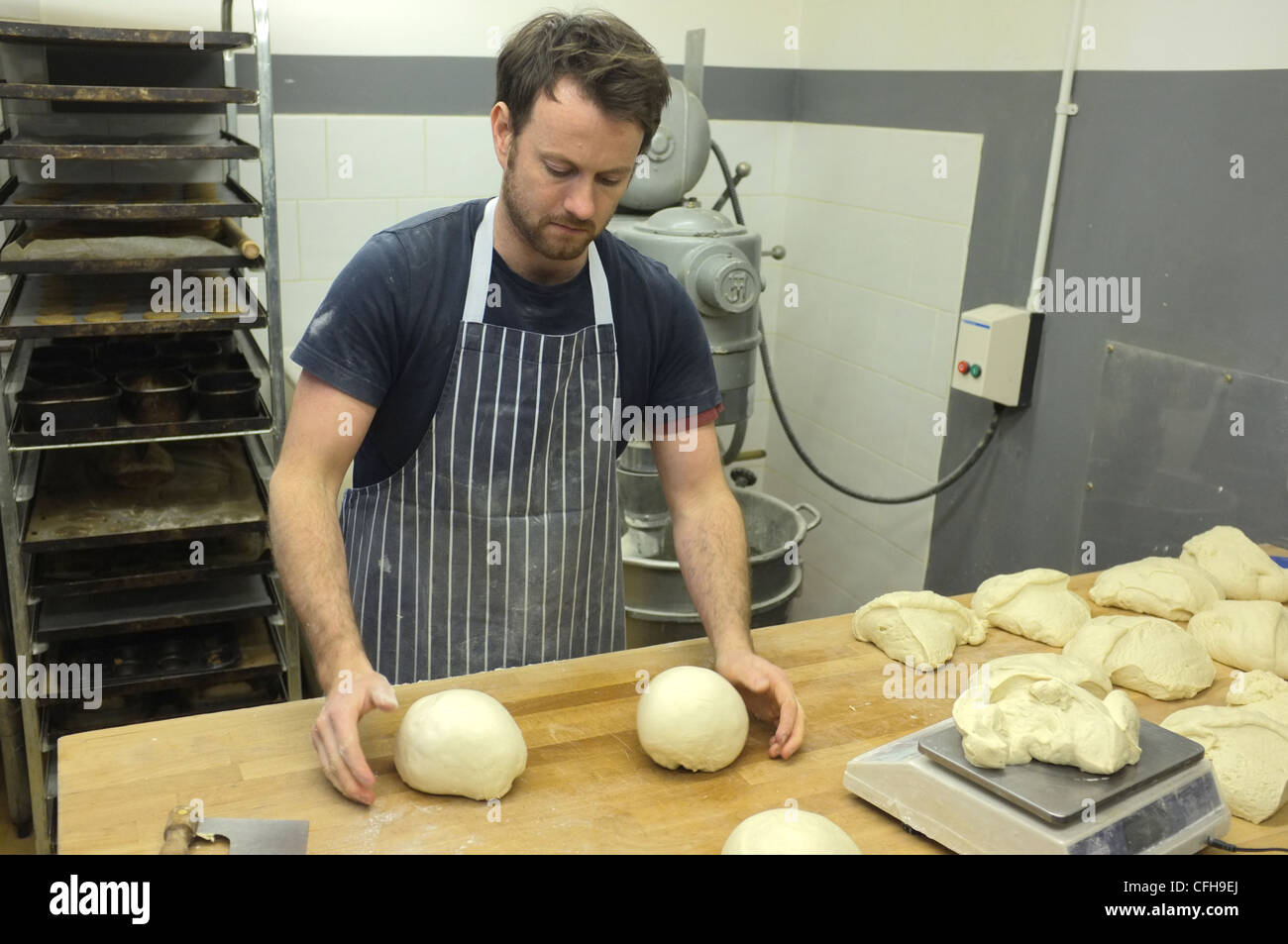 An artisan baker producing bread and buns Stock Photo - Alamy