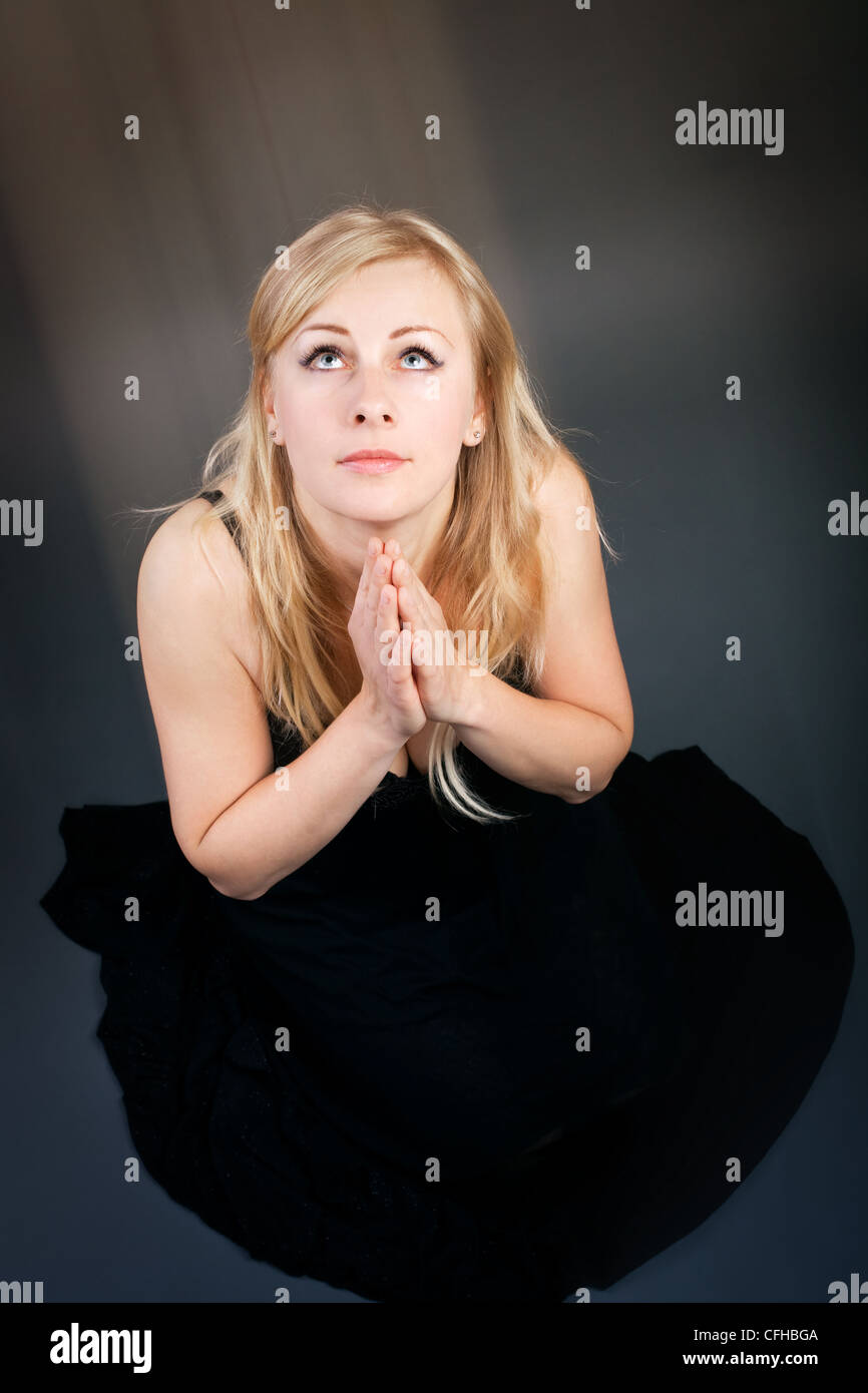 Woman kneeling to pray hi-res stock photography and images - Alamy