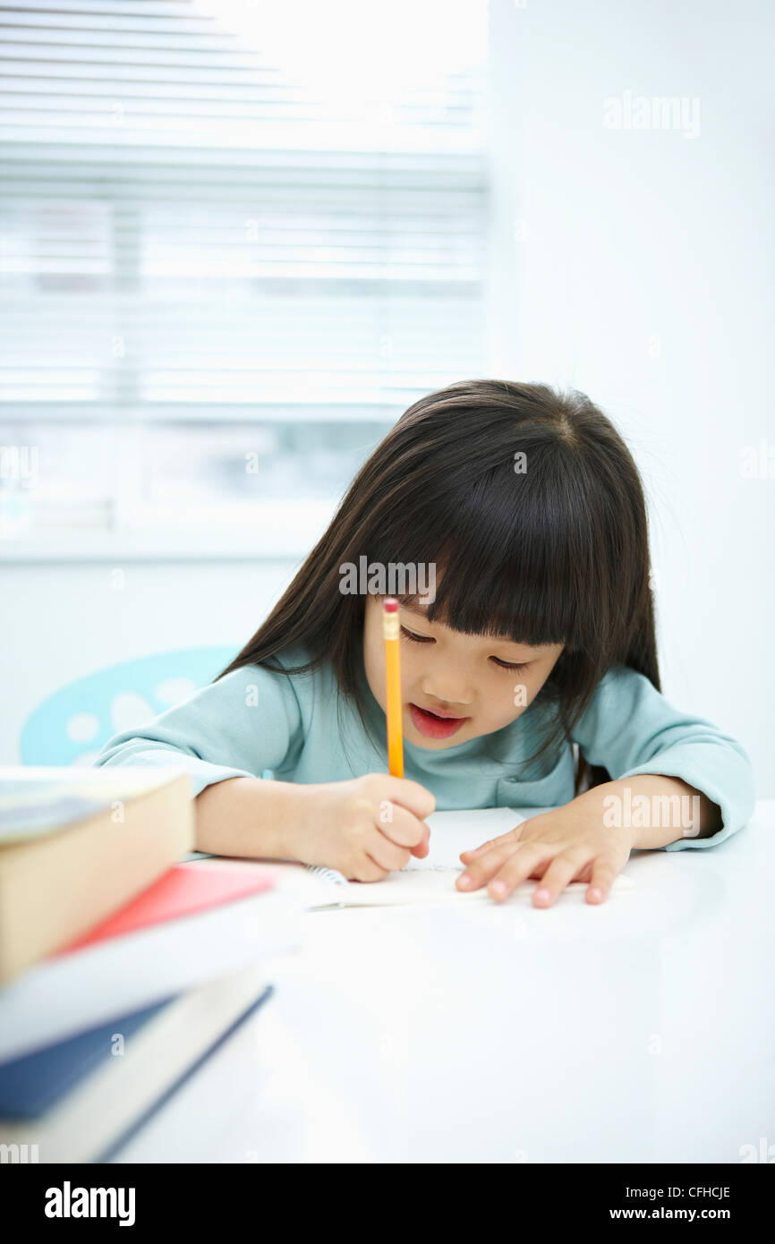 Girl sitting on the floor writing book hi-res stock photography and ...