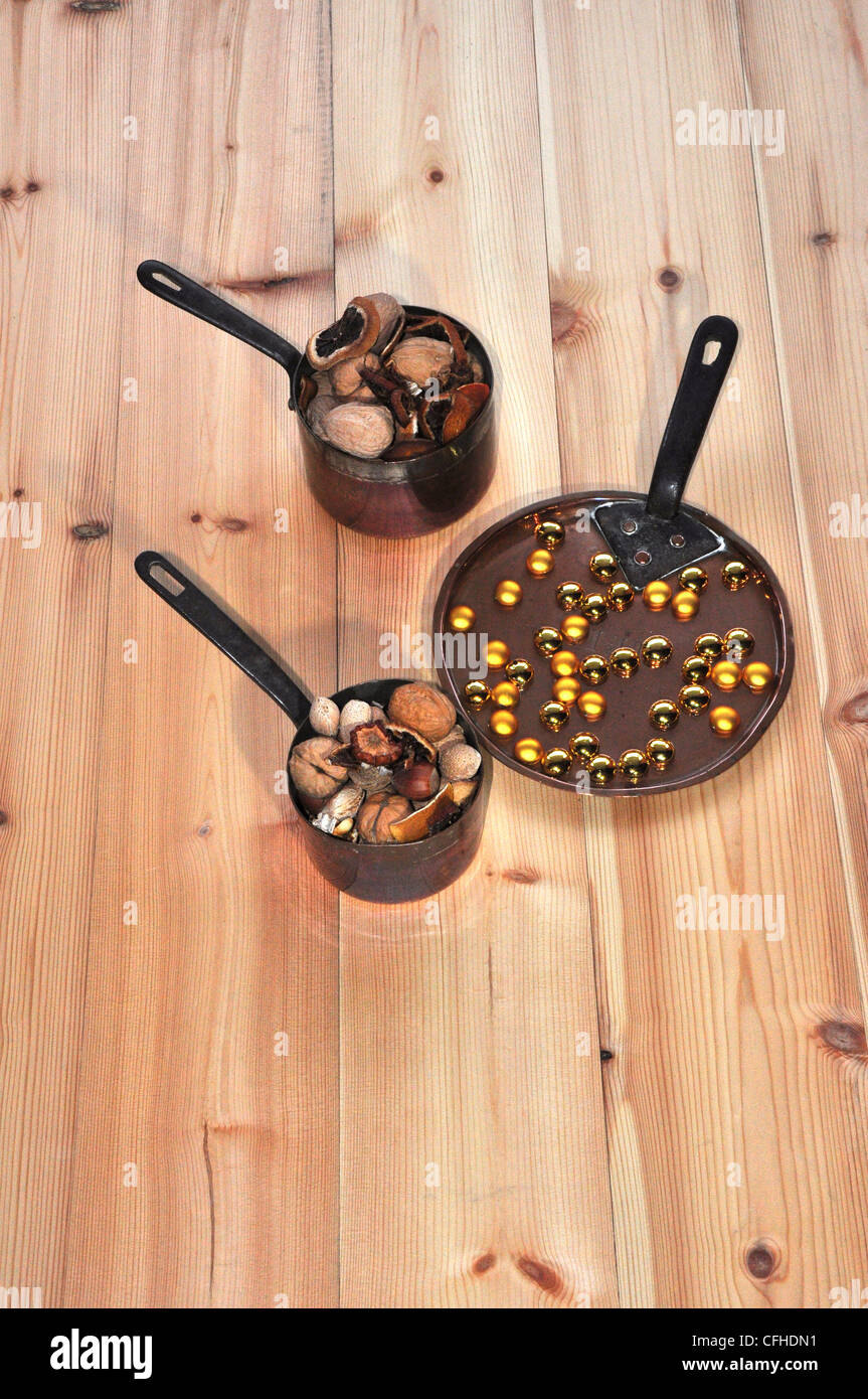 Victorian copper pans filled with gold beads and dried fruit and nuts ...