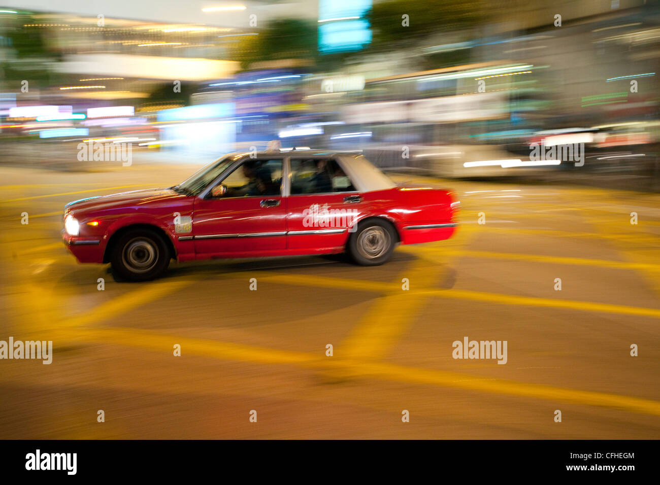 Speeding red taxi in Hong Kong Stock Photo - Alamy